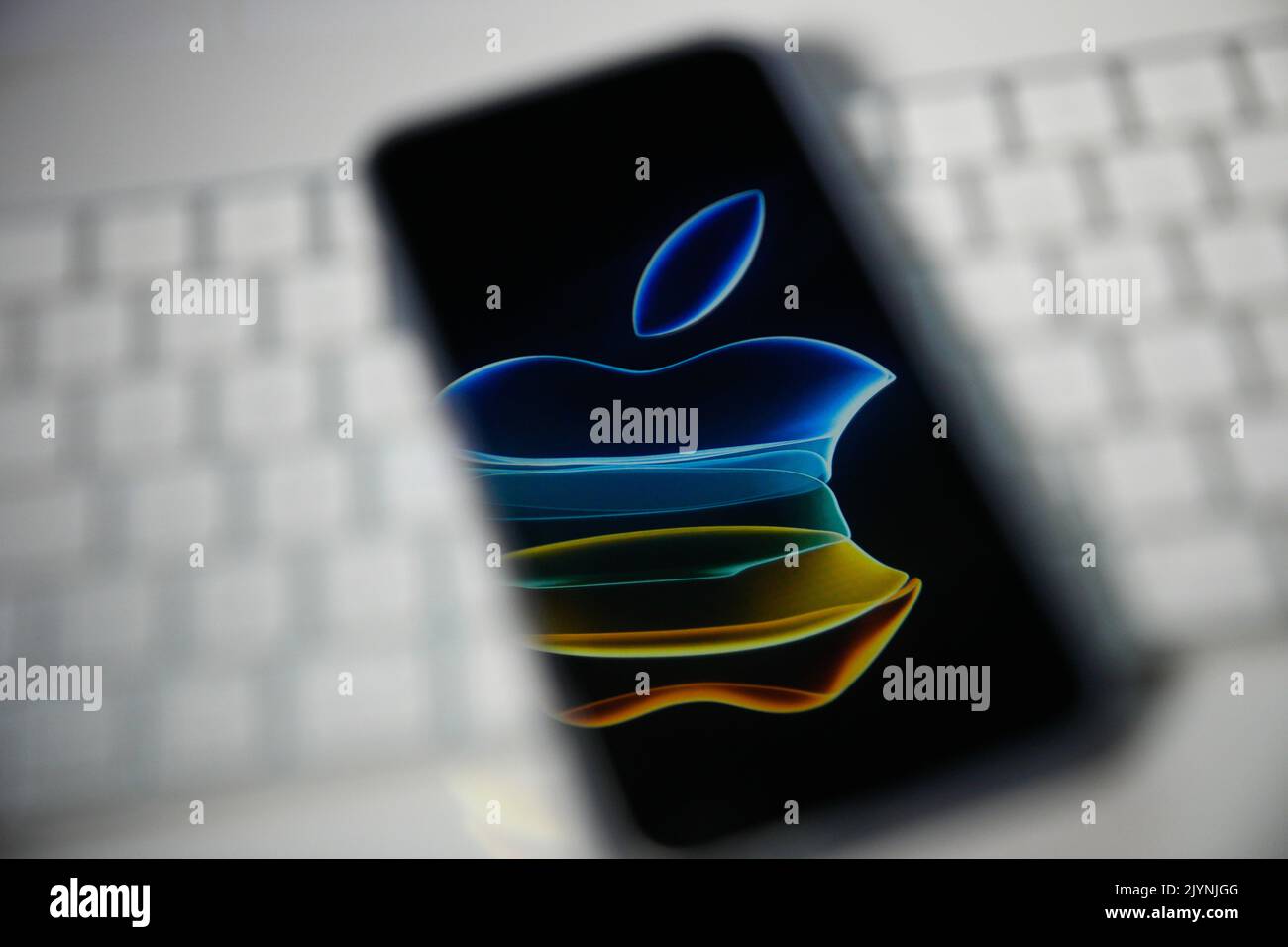 The Apple logo and the iPhone 14 logo are seen on a portable device in ...