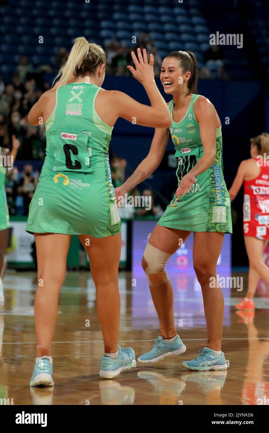 Emma Cosh (right) Jess Anstiss of the Fever celebrate after winning the ...
