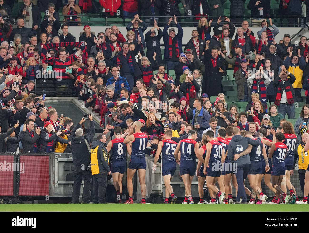 Demons fans in the crowd show their support as the Demons leave the ...