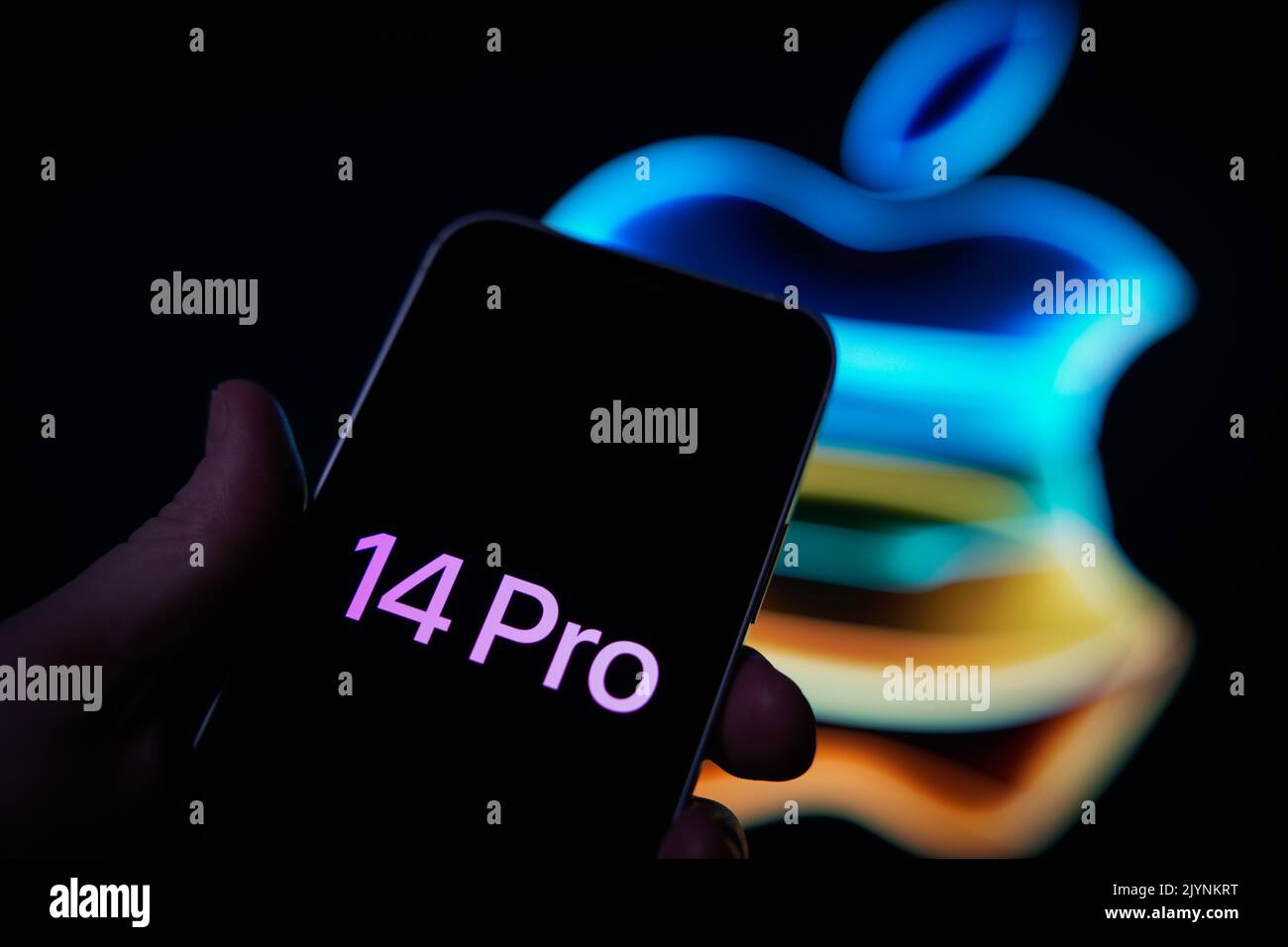 The Apple logo and the iPhone 14 logo are seen on a portable device in ...