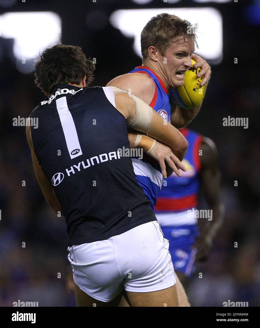 Alex Keath of the Bulldogs is tackled by Jack Silvagni of the Blues ...