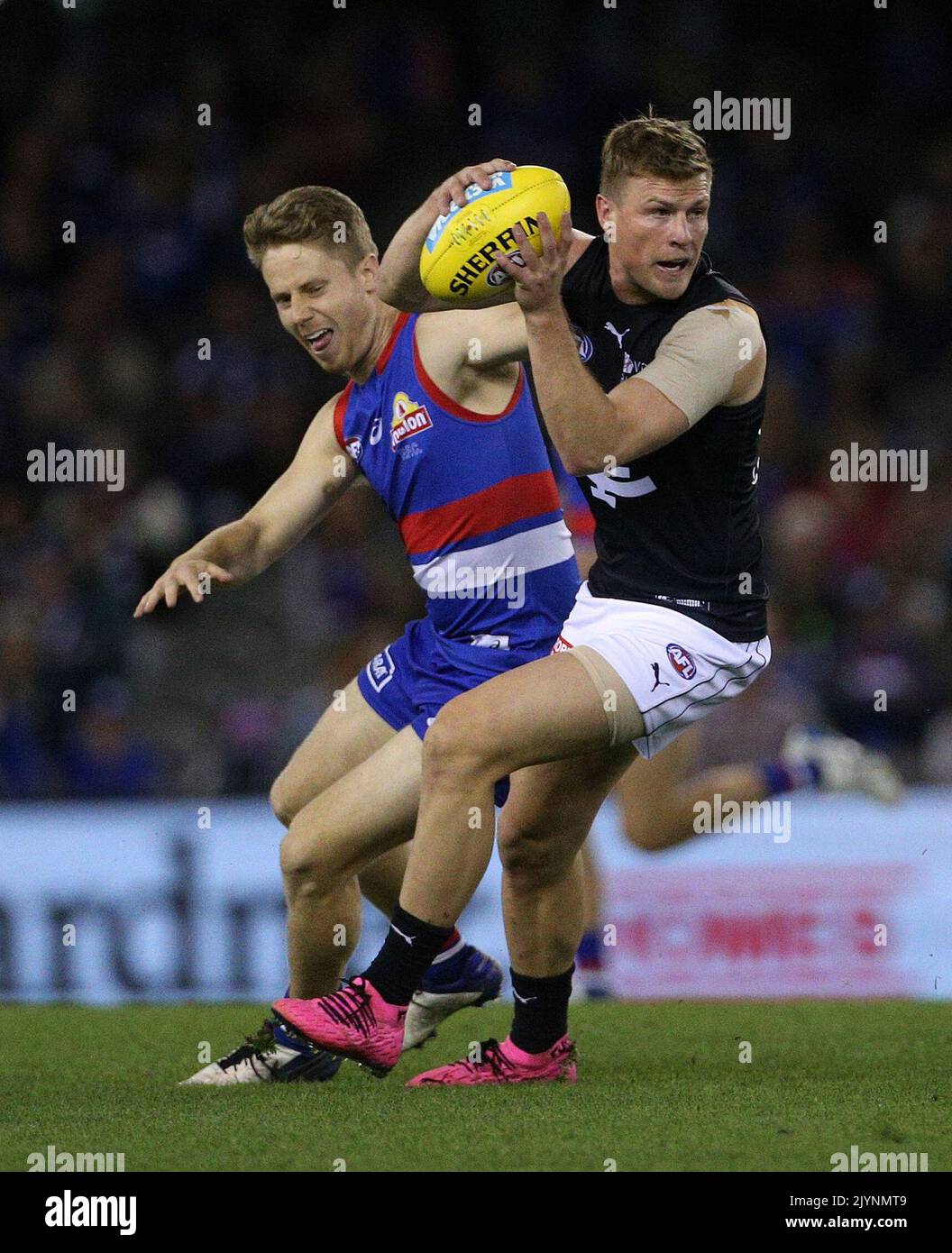 Jack Newnes of the Blues under pressure from Lachie Hunter of the ...