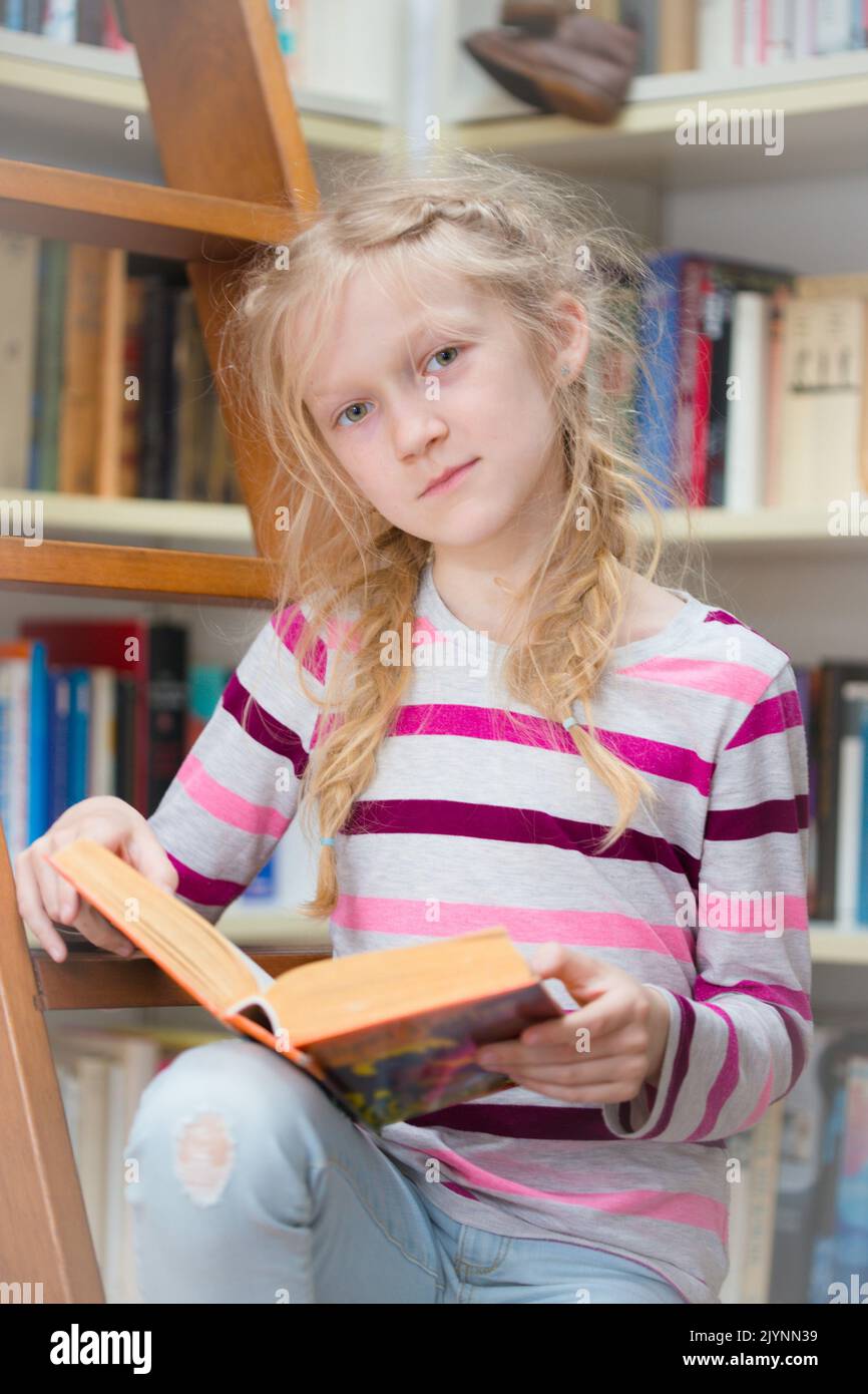 child reading a book at the private library Stock Photo - Alamy