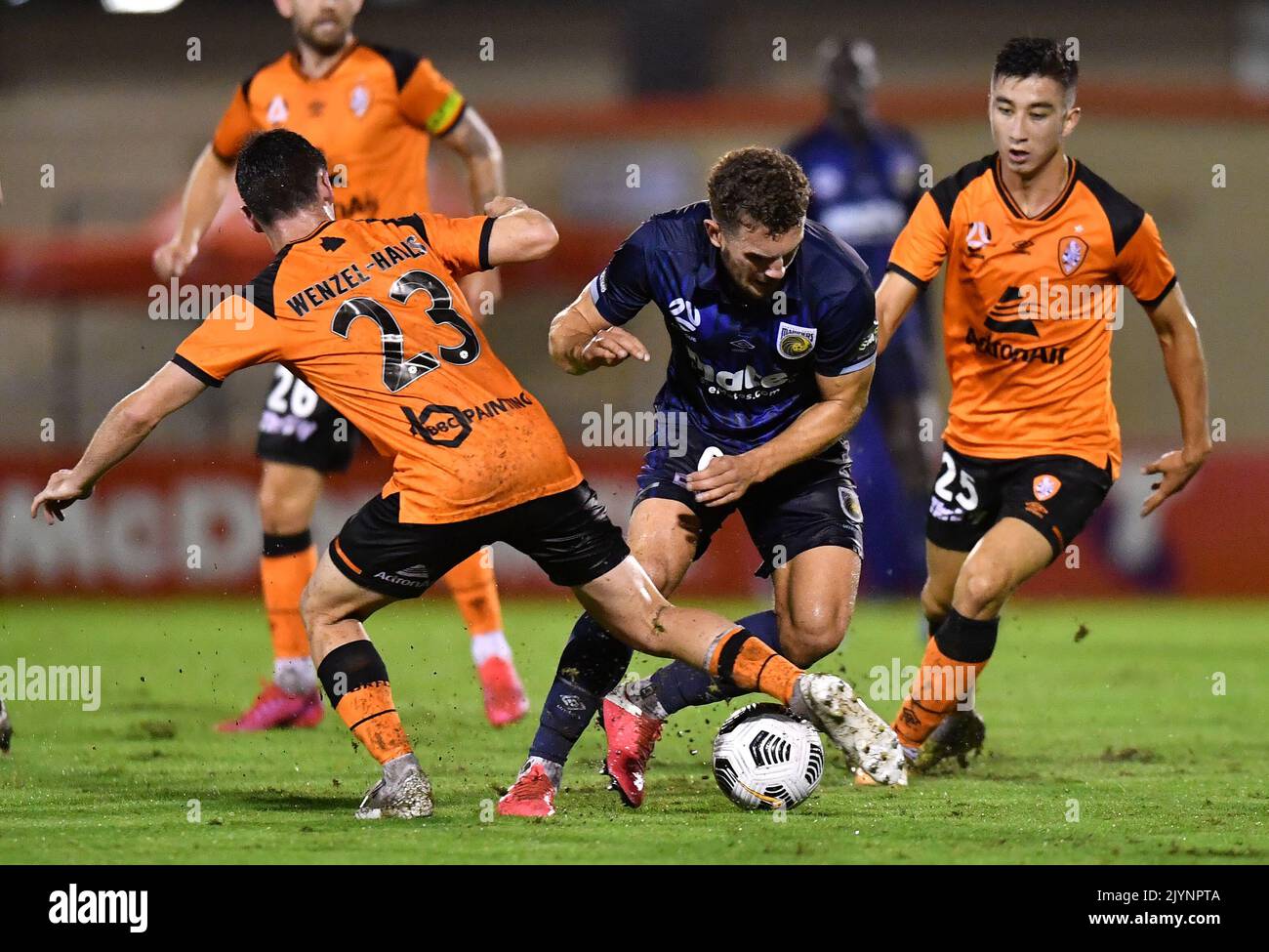 Gianni Stensness (centre) of the Mariners contests for the ball against ...