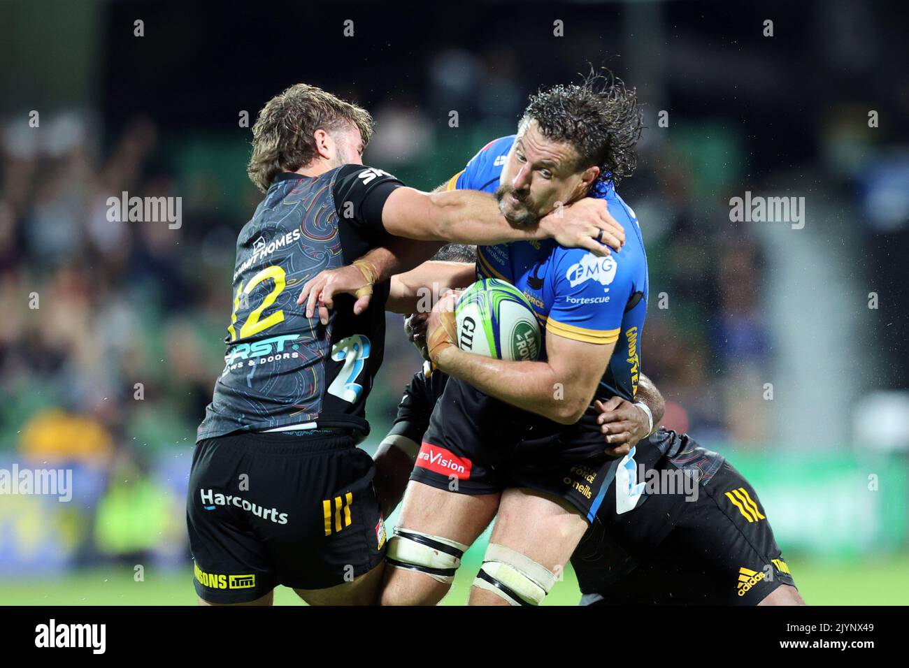 Jeremy Thrush of the Force (right) is stopped by Chiefs Alex Nankivell ...