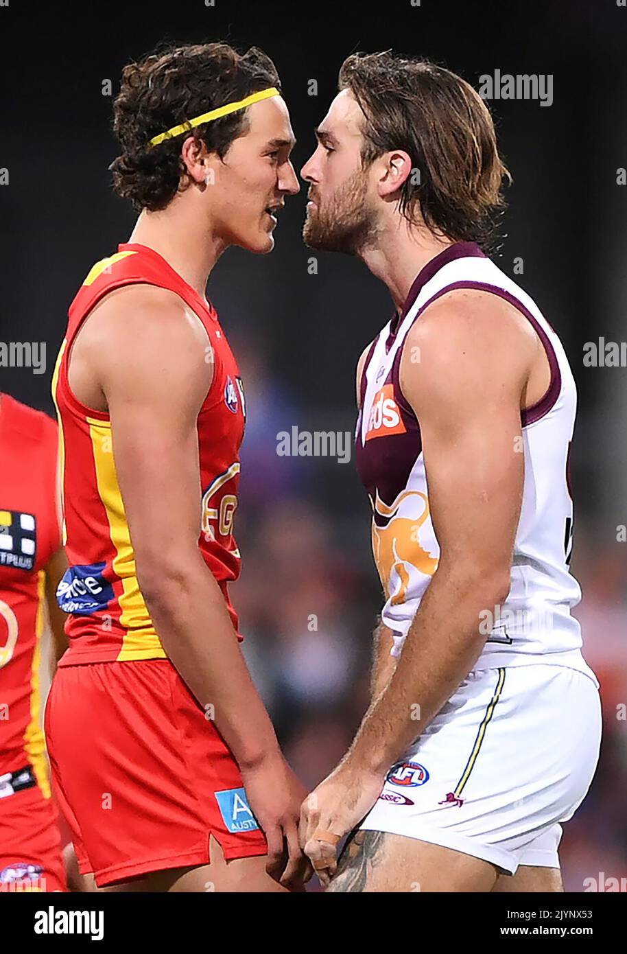 Wil Powell of the Suns (left) reacts with Rhys Mathieson of the Lions ...
