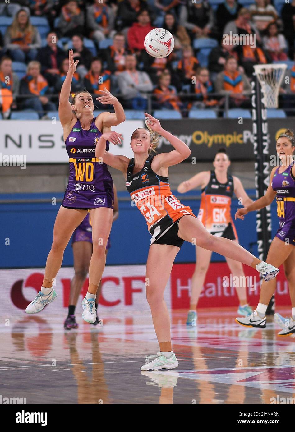 Gabi Simpson of the Firebirds and Sophie Dwyer of the Giants in action ...