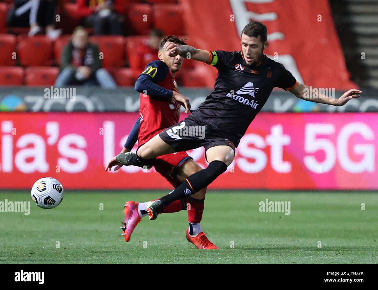 Scott Neville of Brisbane Roar and Joshua Cavallo of United during the ...