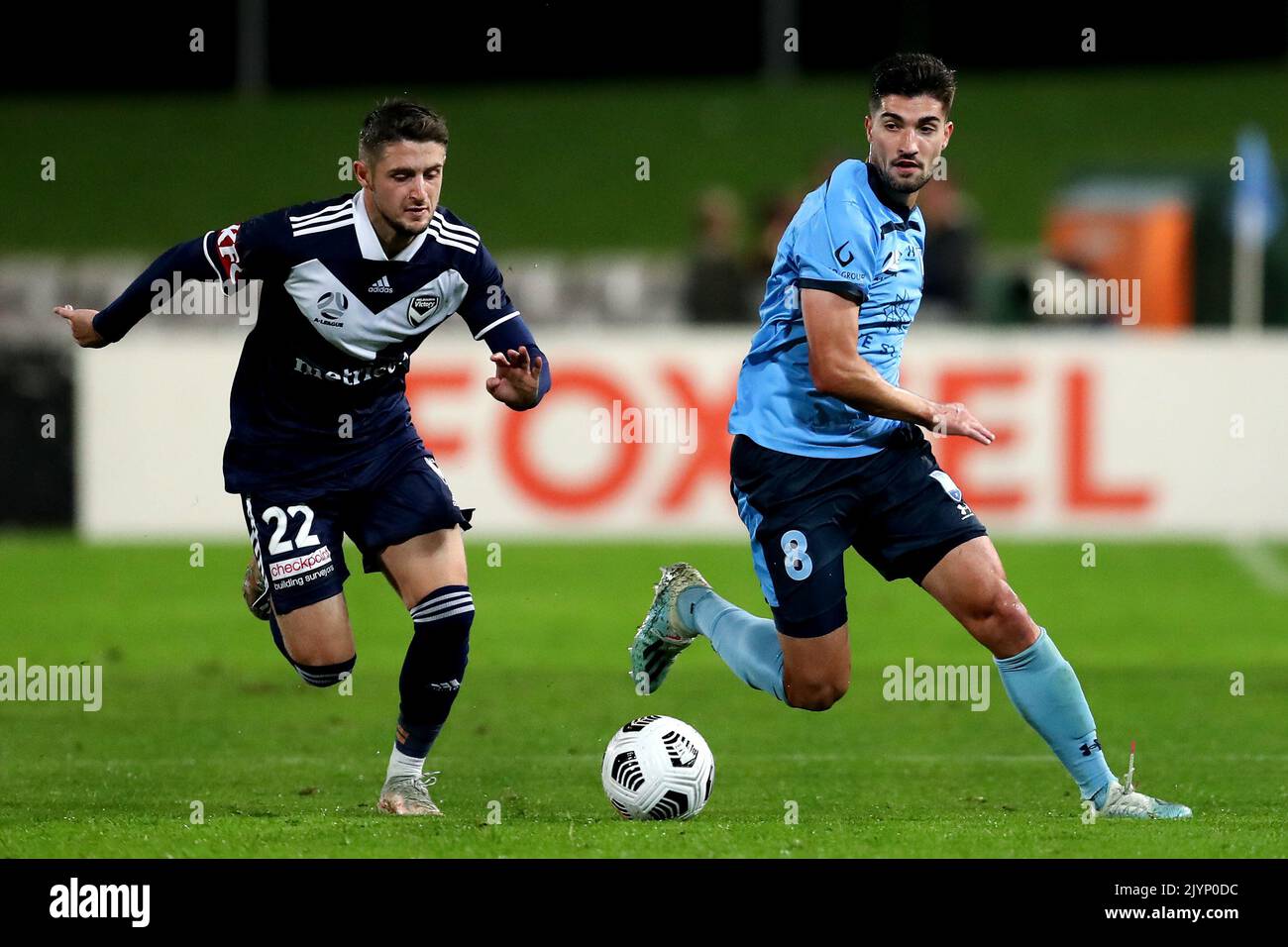 Paulo Retre of Sydney competes with Jake Brimmer of the Victory during ...