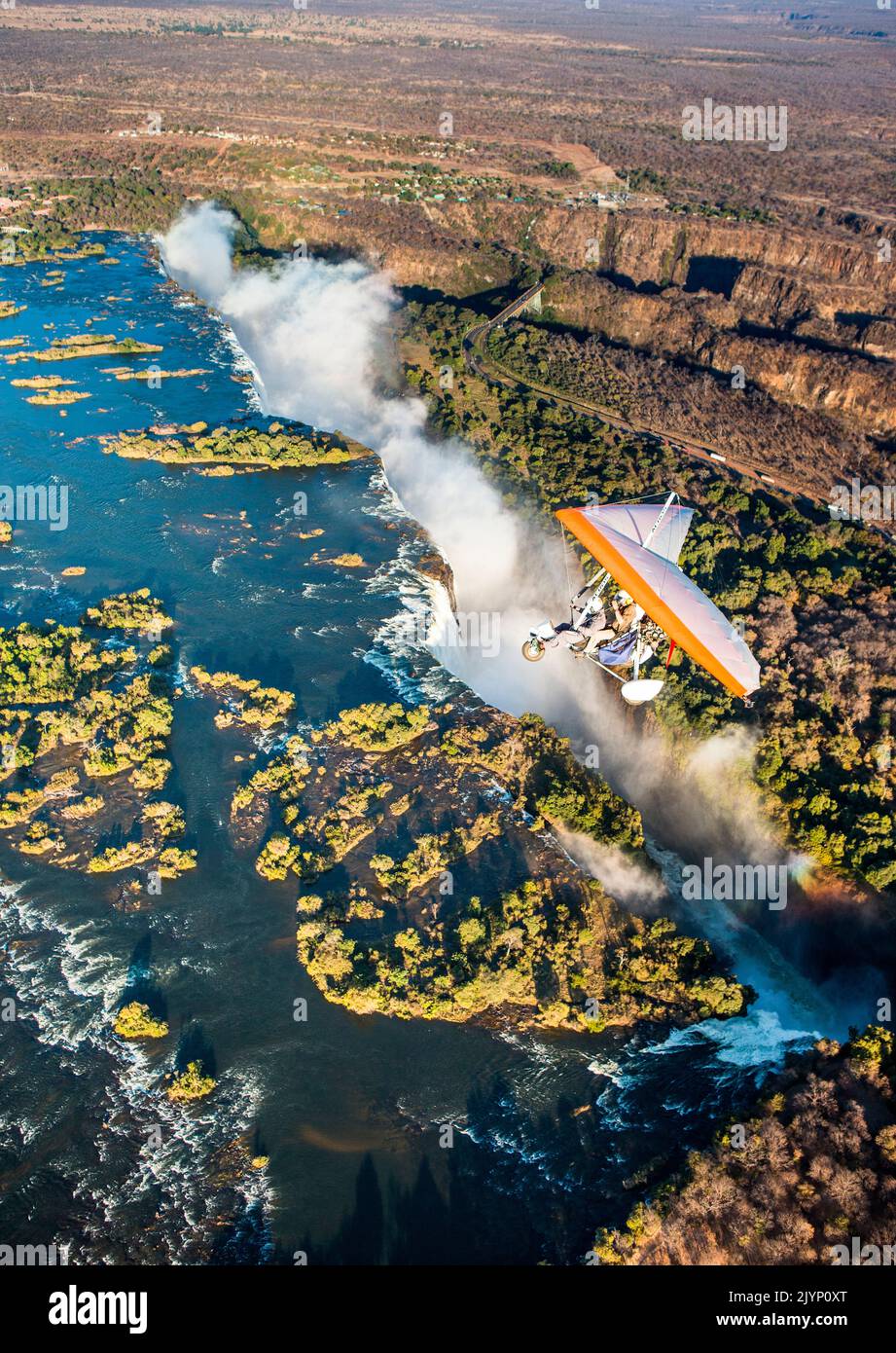 Tourists fly over the Victoria Falls on the trikes. Africa. Zamb Stock ...