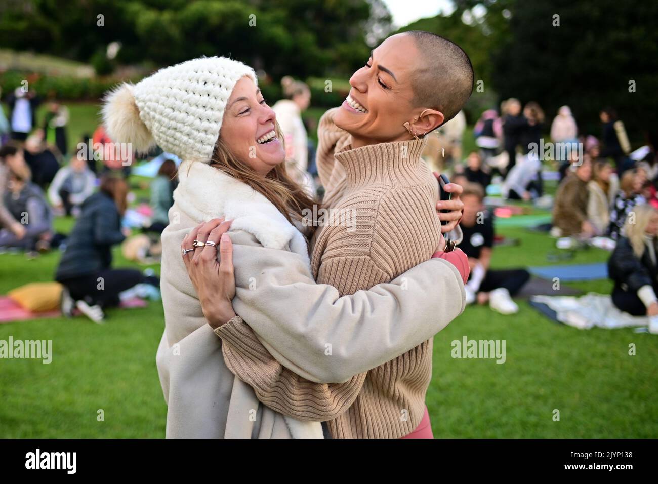 A guest embraces host Leah Simmons following a mass meditation class to ...