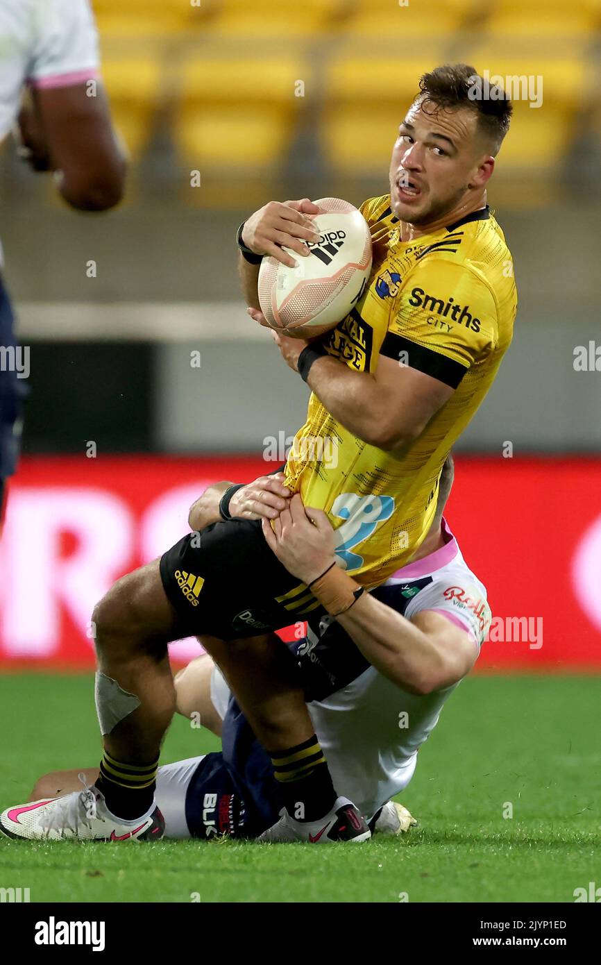 Wes Goosen of the Hurricanes (top) is tackled by George Worth of the ...