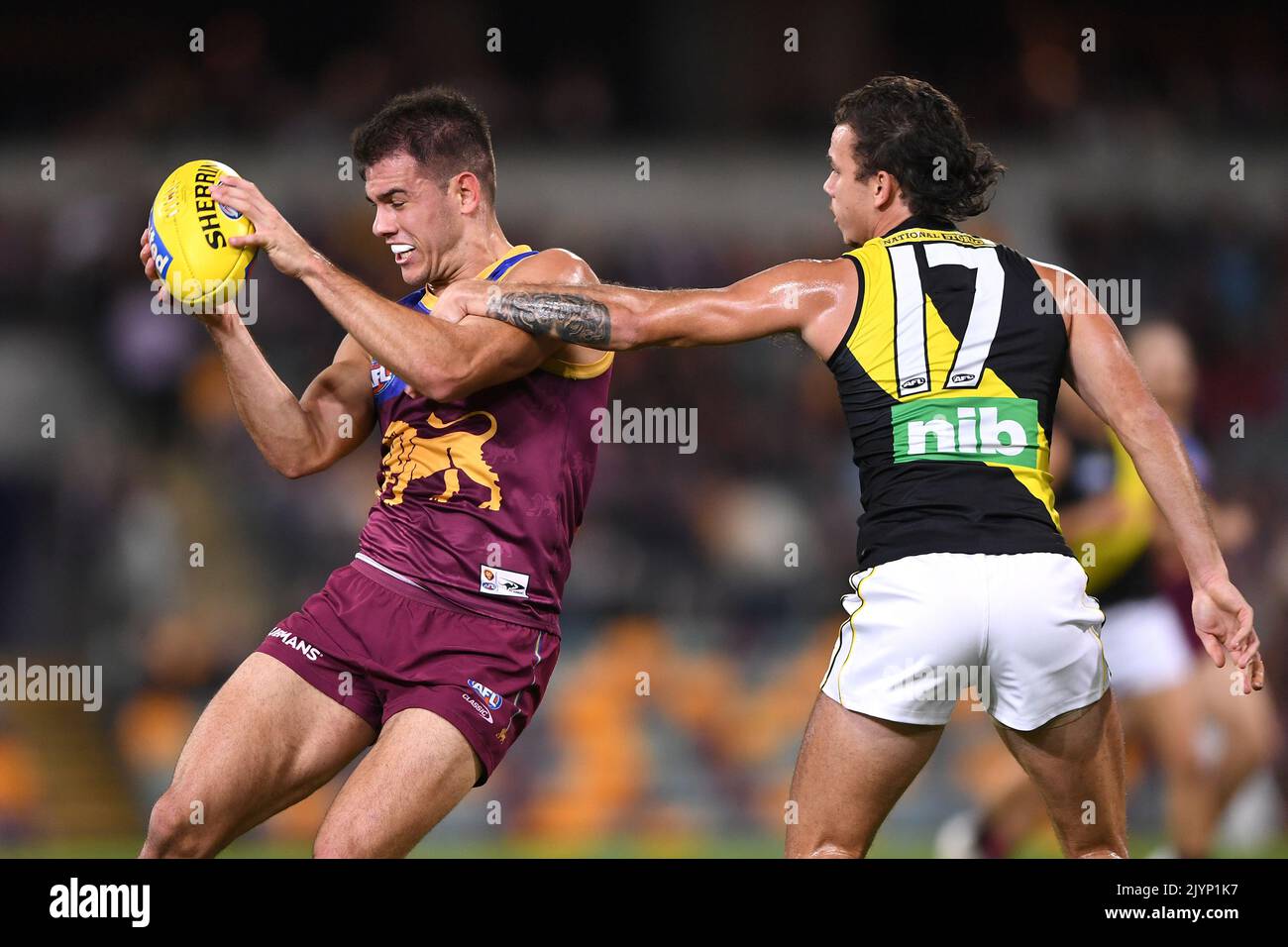 Branden Starcevich of the Lions takes a mark ahead of Daniel Rioli of ...
