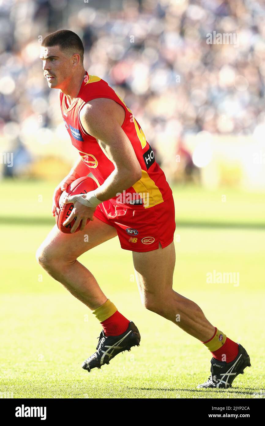 Sam Collins of the Suns runs with the ball during the Round 10 AFL ...