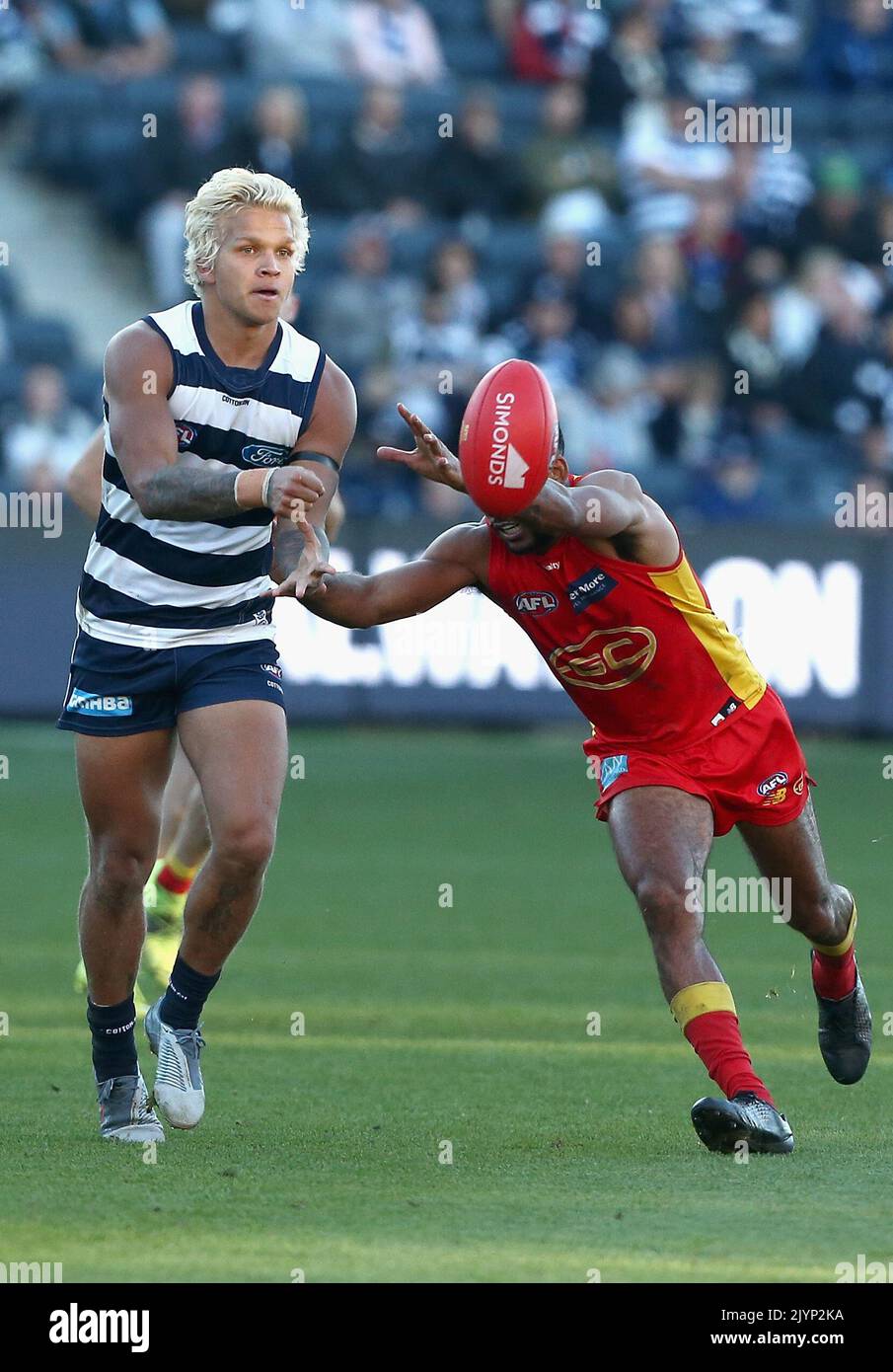Quinton Narkle of the Cats handballs during the Round 10 AFL match ...