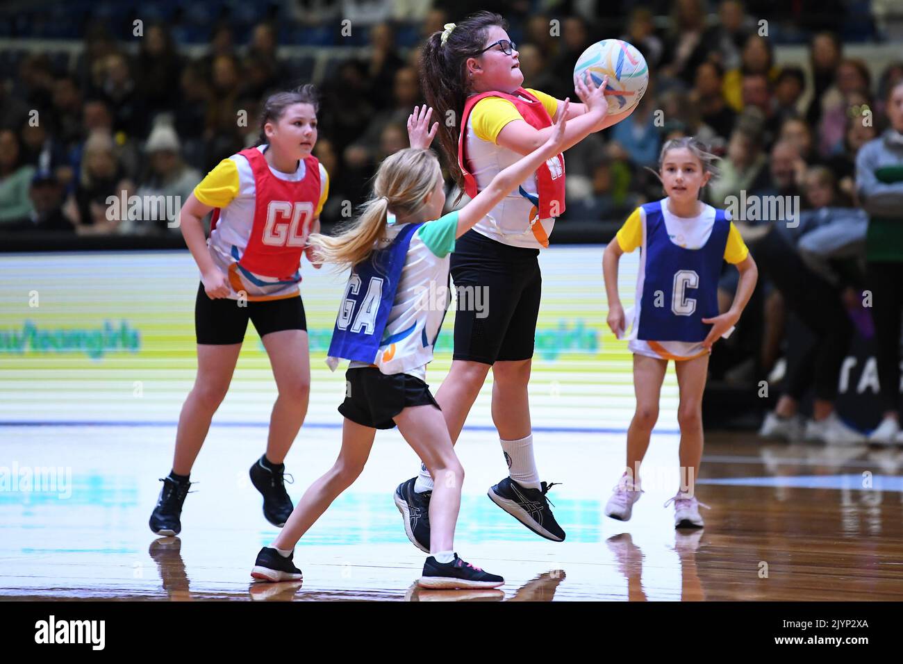 Children play netball on court during half time at the Round 4 Super ...