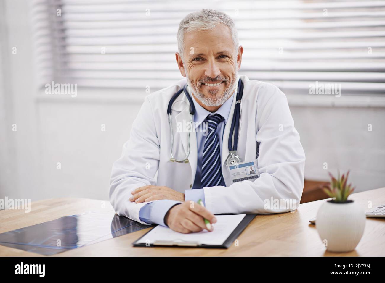 Your health is what he works for. Portrait of a mature male doctor ...