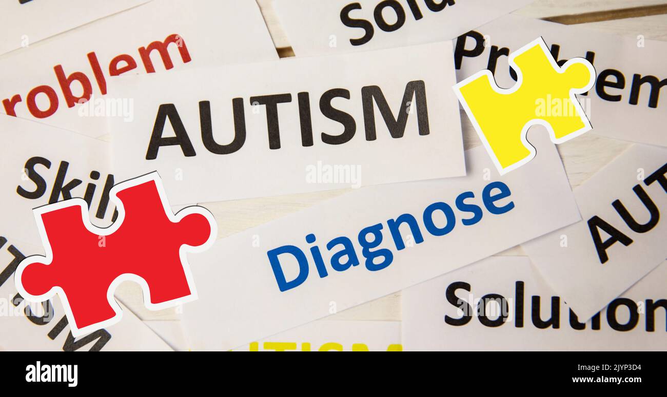 Image of red and yellow puzzle pieces falling over autism text on white ...