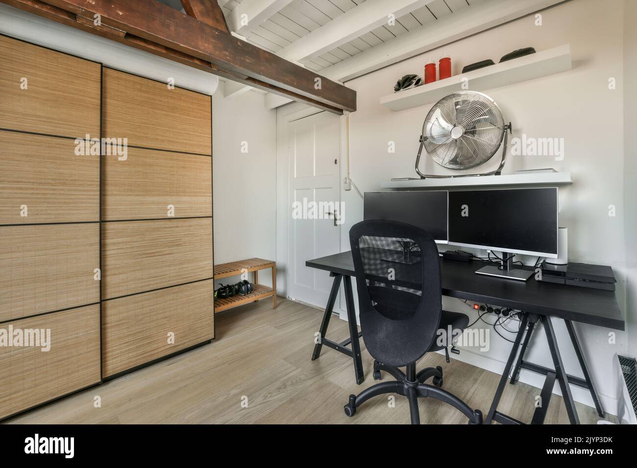 mansard of light home office with desk and cupboard near window Stock ...