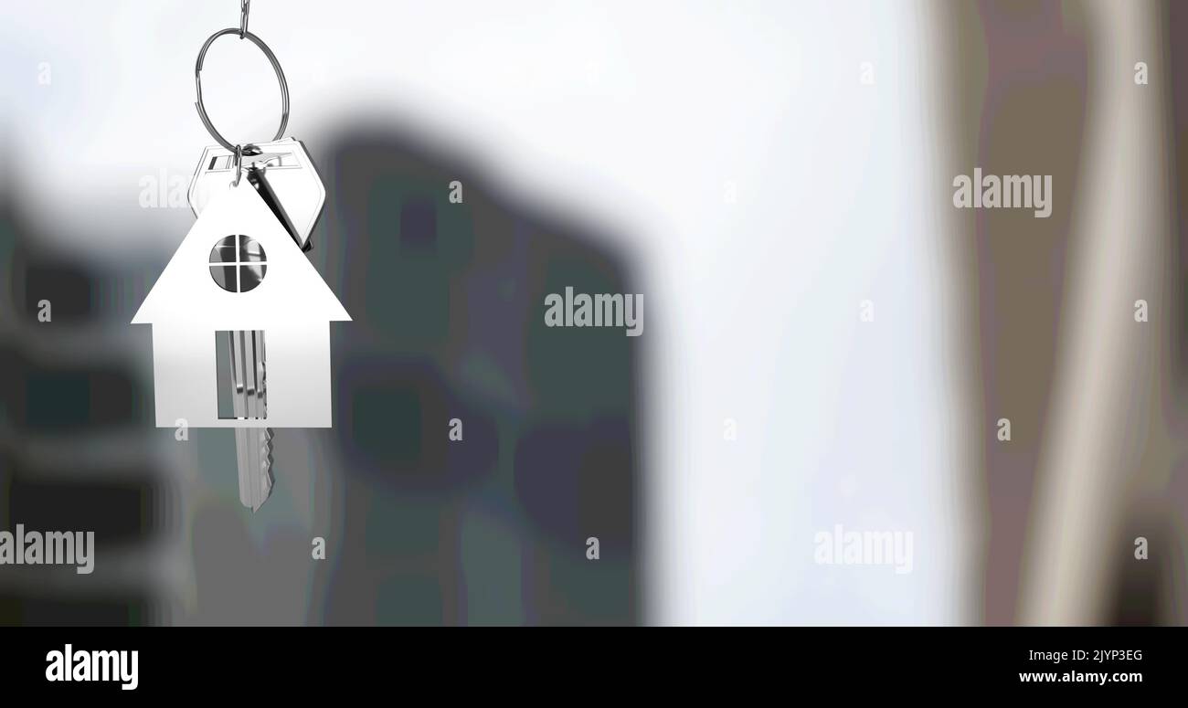 Image of silver house key fob and key, hanging in front of blurred city ...