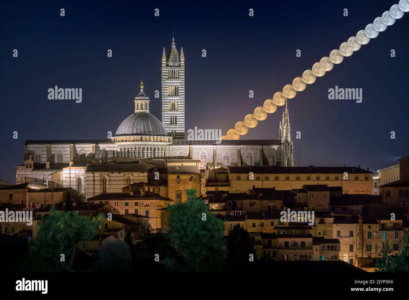 The Moon behind the Siena's cathedral at night, Tuscany, Italy Stock ...