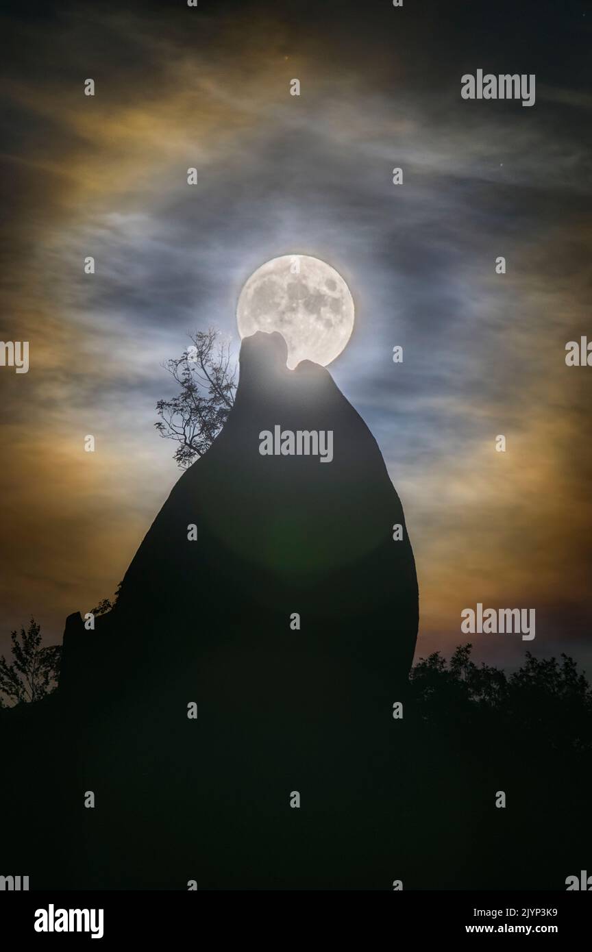 Moon halo behind the wolf rock, Parma, Italy Stock Photo - Alamy
