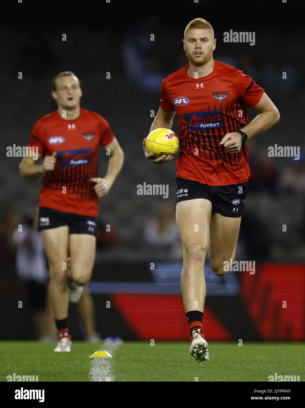 Peter Wright of the Bombers (right) warms up before the Round 10 AFL ...