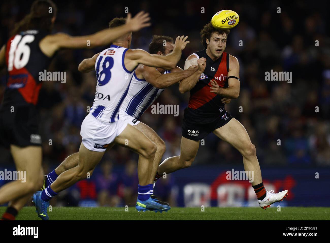 Andrew McGrath of the Bombers (right) handballs during the Round 10 AFL ...