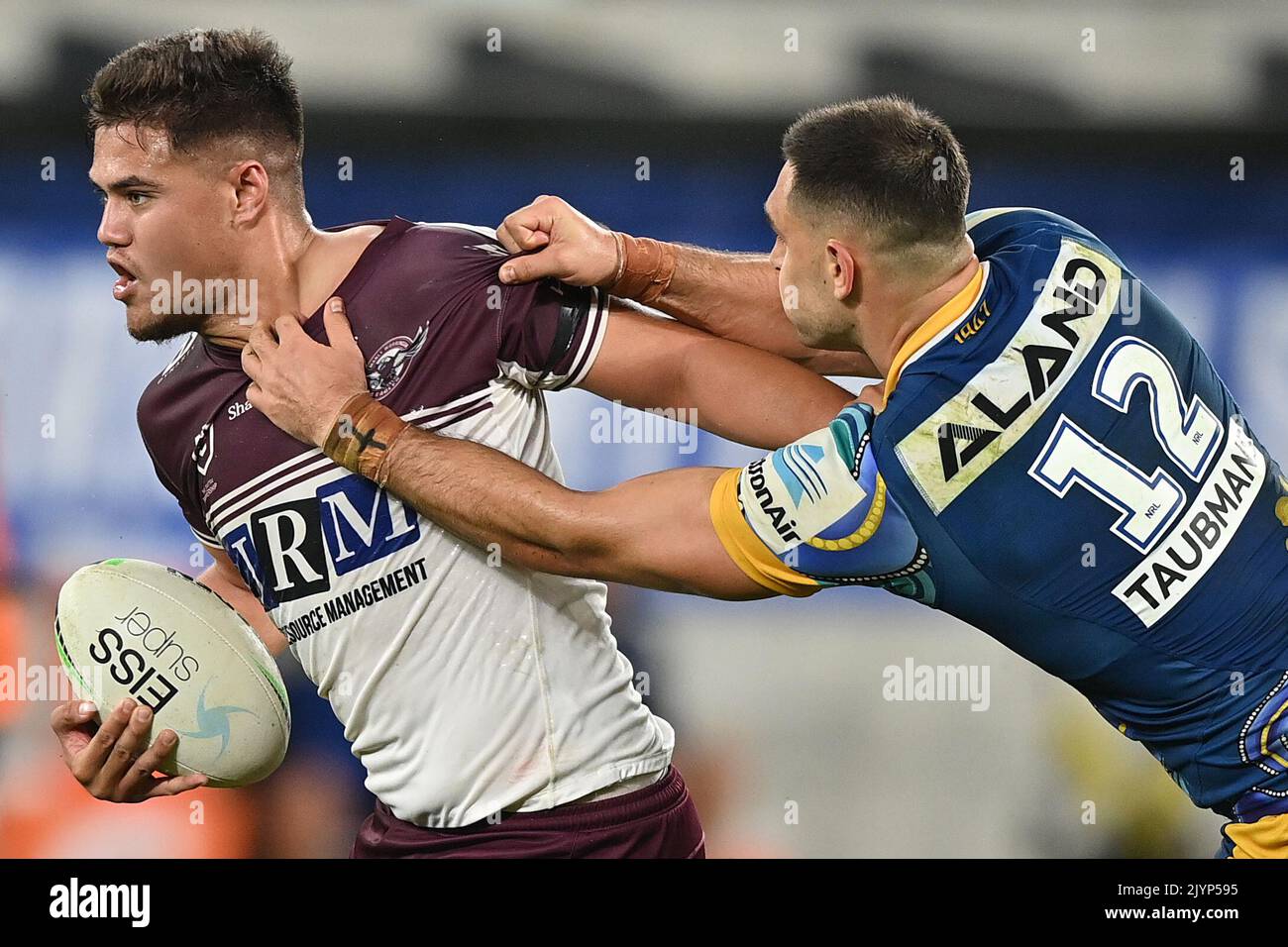 Ryan Matterson of the Eels tackles Josh Schuster of the Sea Eagles ...