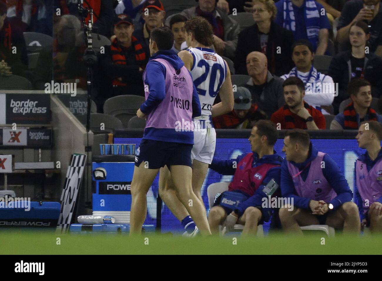 Nick Larkey of the Kangaroos leaves the field with a physio during the ...
