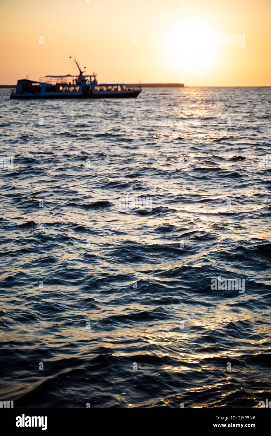 ship at sunset on the sea Stock Photo - Alamy