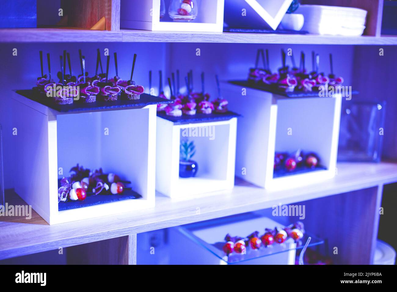 Refined buffet and snacks with blue light Stock Photo - Alamy