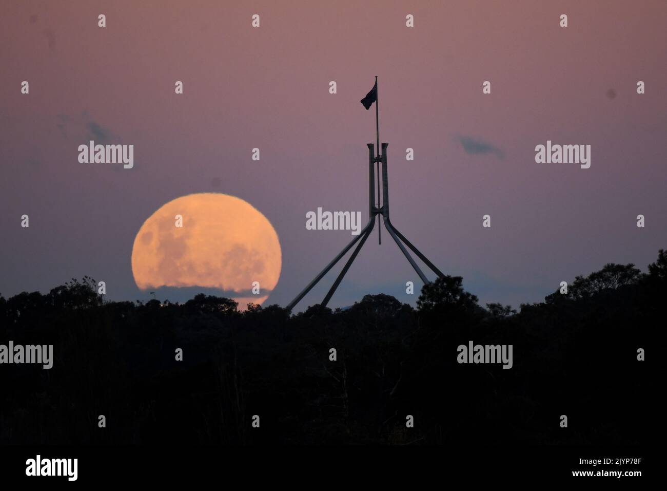 A full moon rises near Parliament House in Canberra, Wednesday, May 26 ...