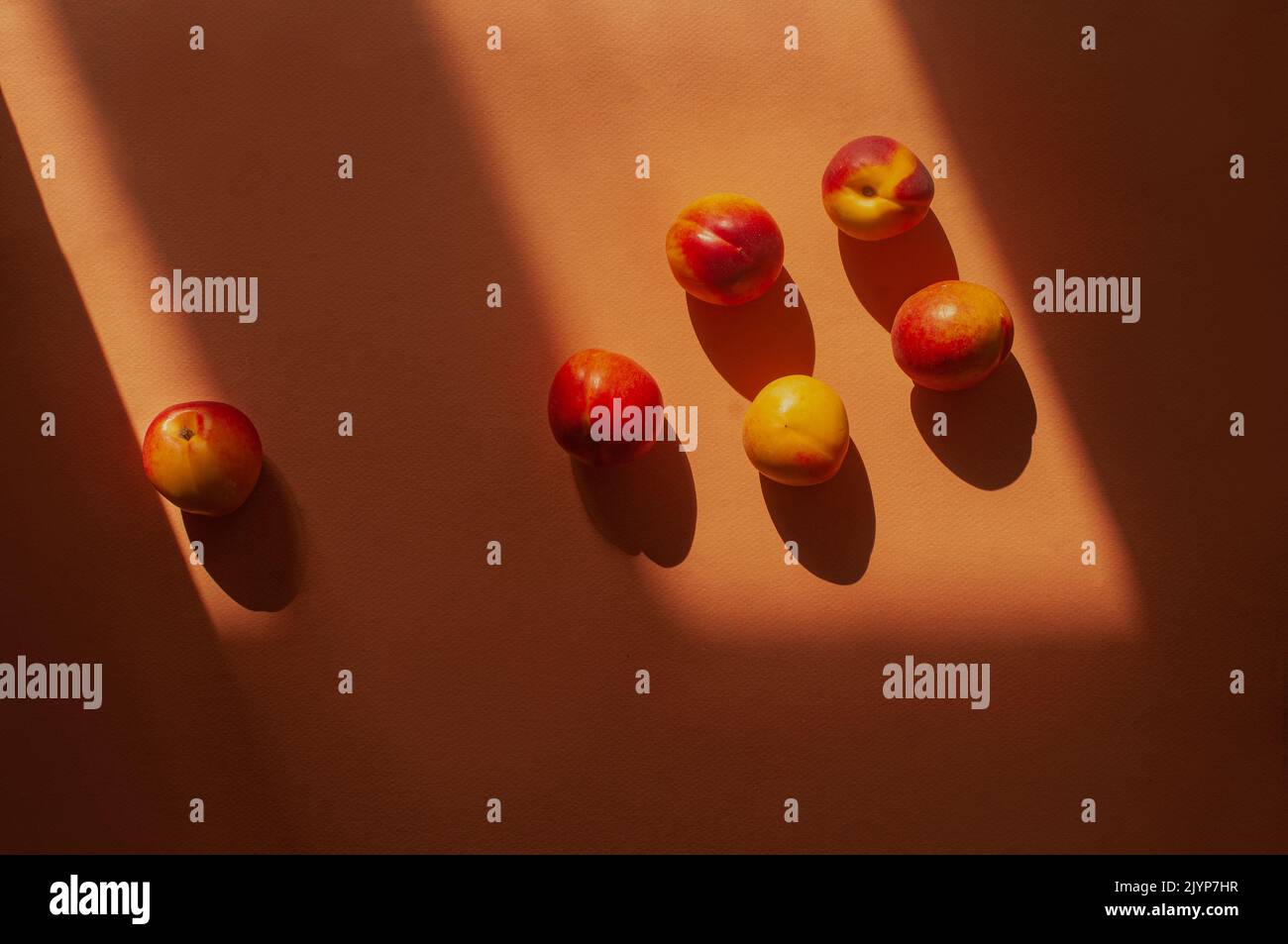 Top down flat lay orange colorful shot peaches and shadow summer food ...