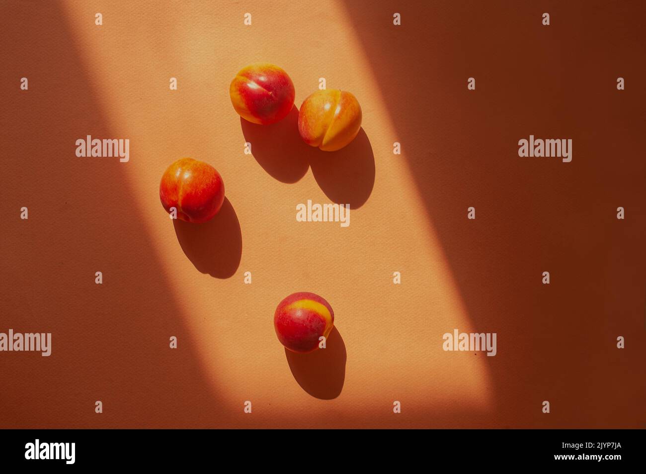 Top down flat lay orange colorful shot peaches and shadow summer food ...