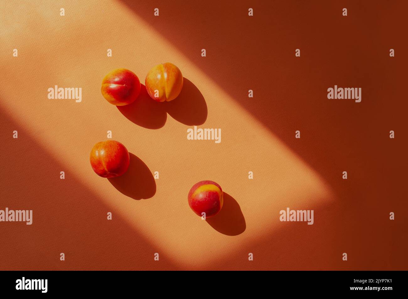 Top down flat lay orange colorful shot peaches and shadow summer food ...