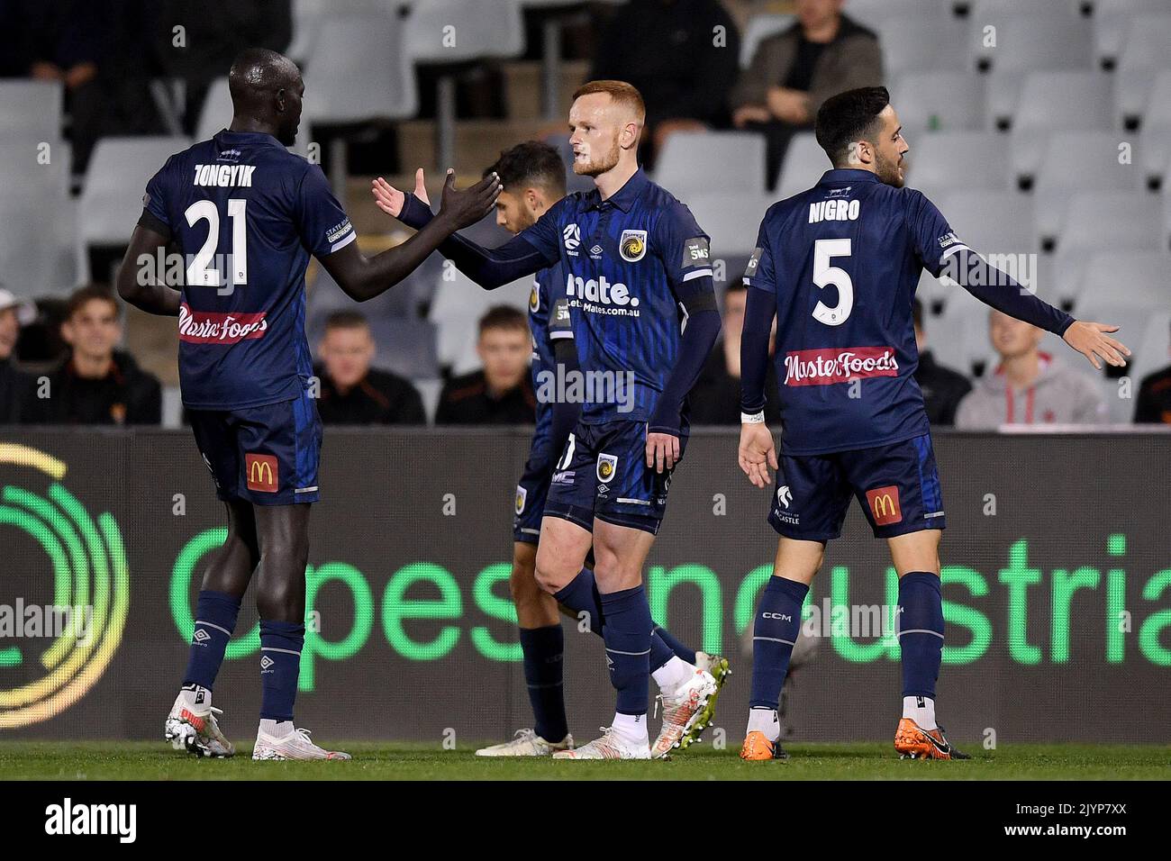 Jack Clisby of the Mariners (centre) celebrates with teammates after ...