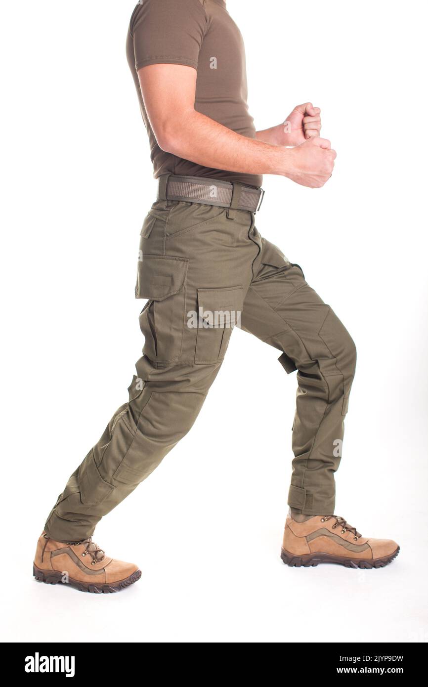 A fighter in military uniform is ready for a fight on a white ...