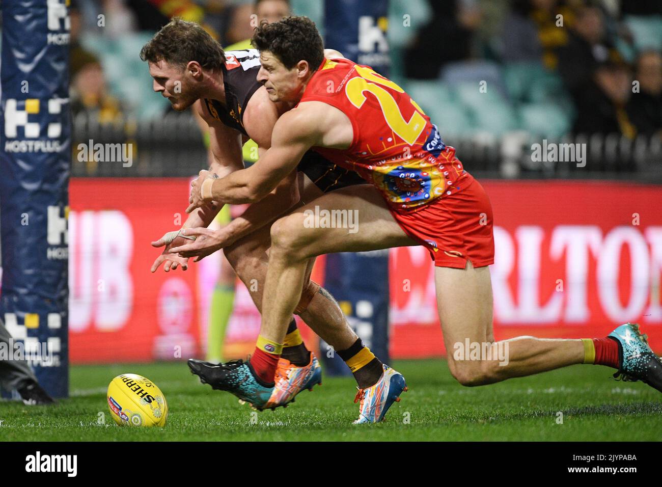 Blake Hardwick of the Hawks is tackled by Chris Burgess of the Suns during the Round 11 AFL ...