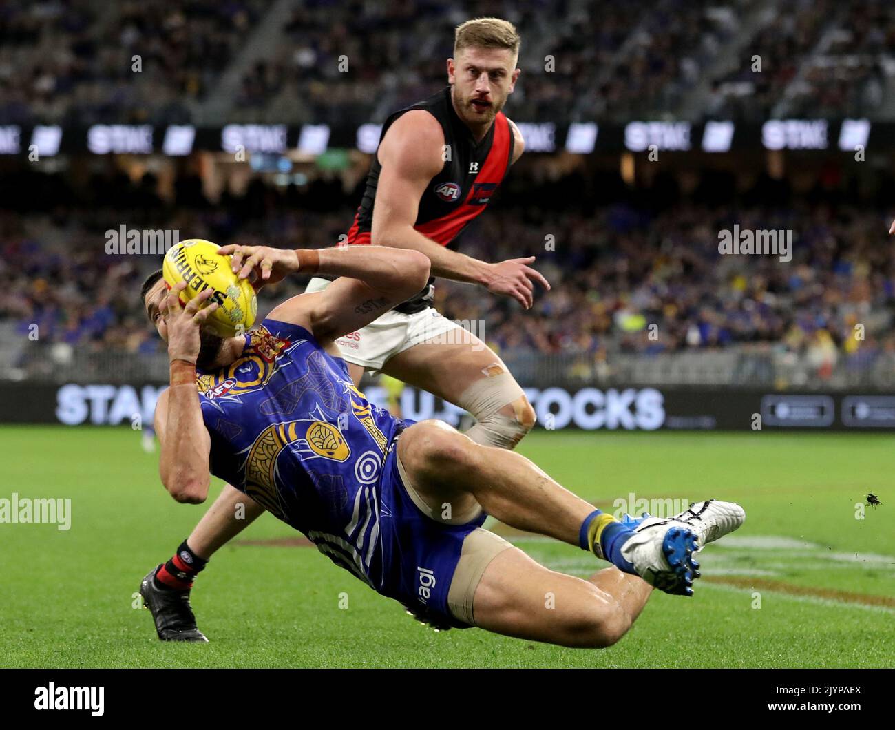 Josh Kennedy of the Eagles slips trying to mark the ball during the ...