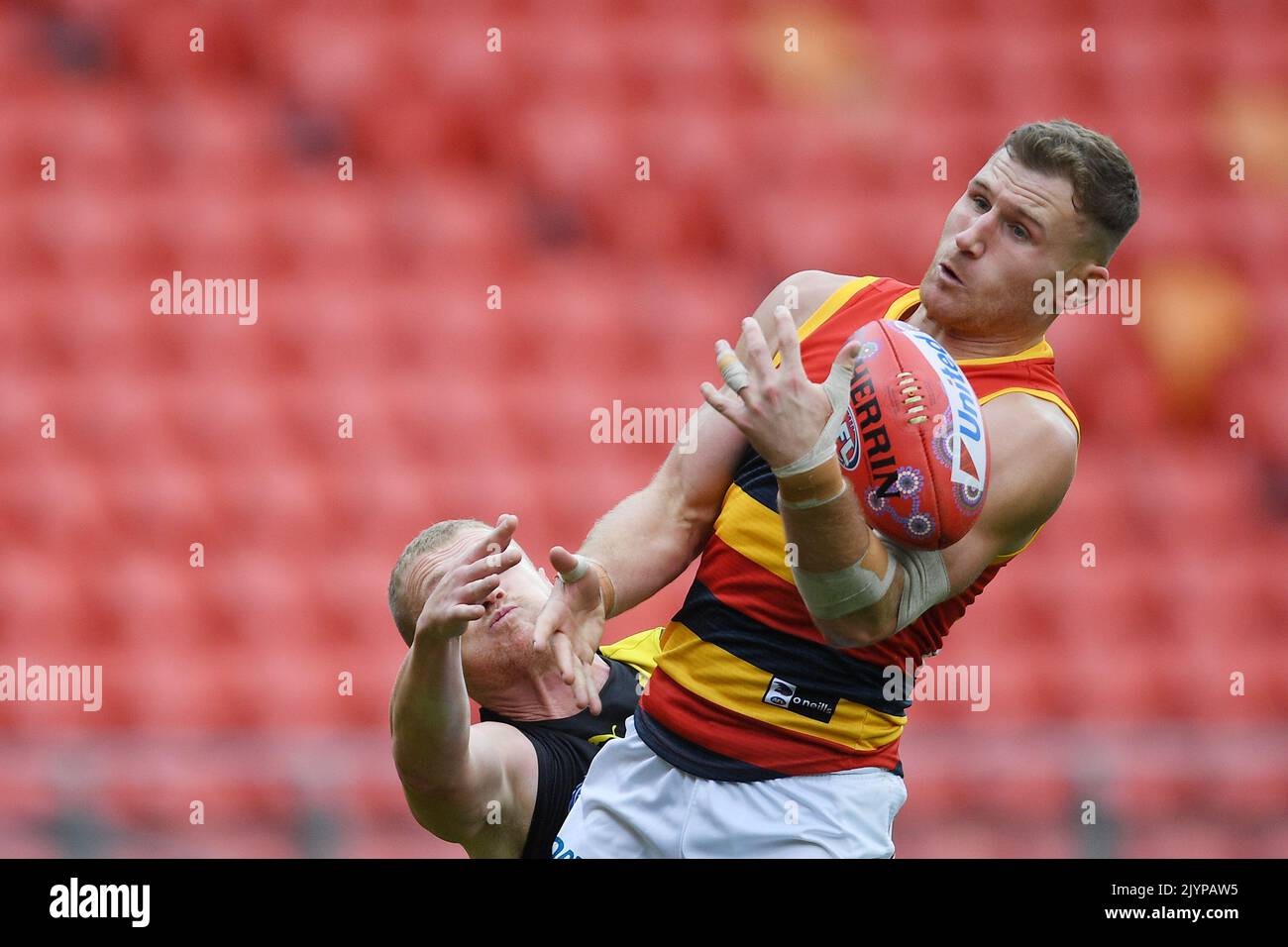 Rory Laird of the Crows takes a mark over Josh Caddy of the Tigers ...