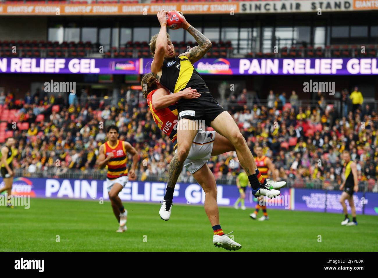 Nathan Broad of the Tigers takes a mark over Sam Berry of the Crows ...