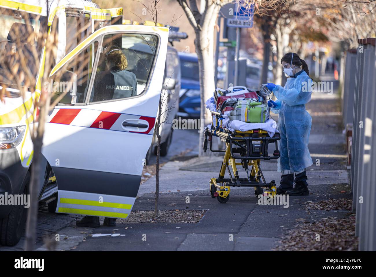 Paramedics return a trolley and equipment to a Paramedic Ambulance ...