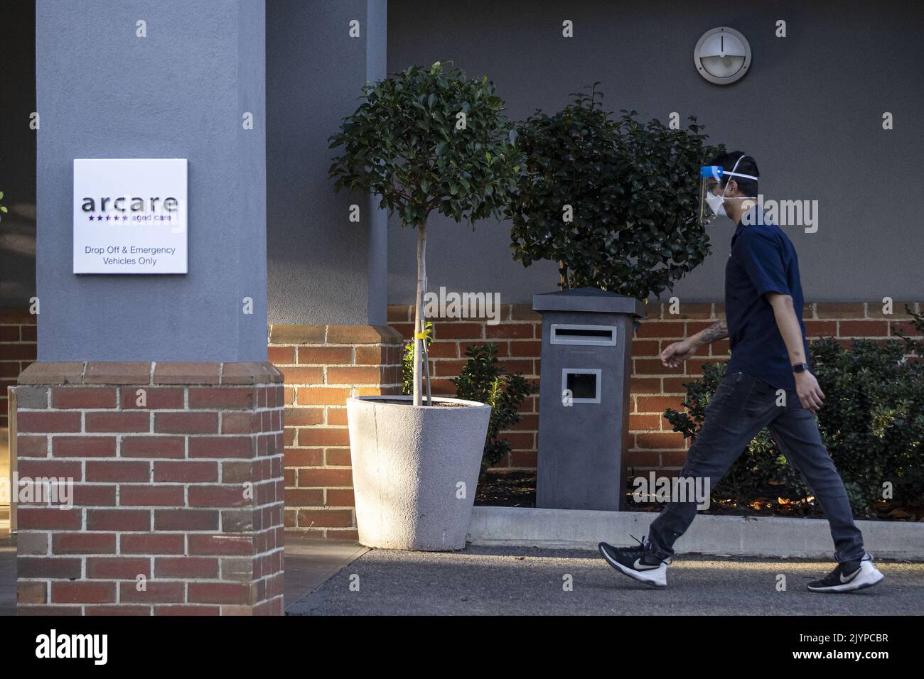 A staff member is seen entering Arcare Aged Care facility in Maidstone ...