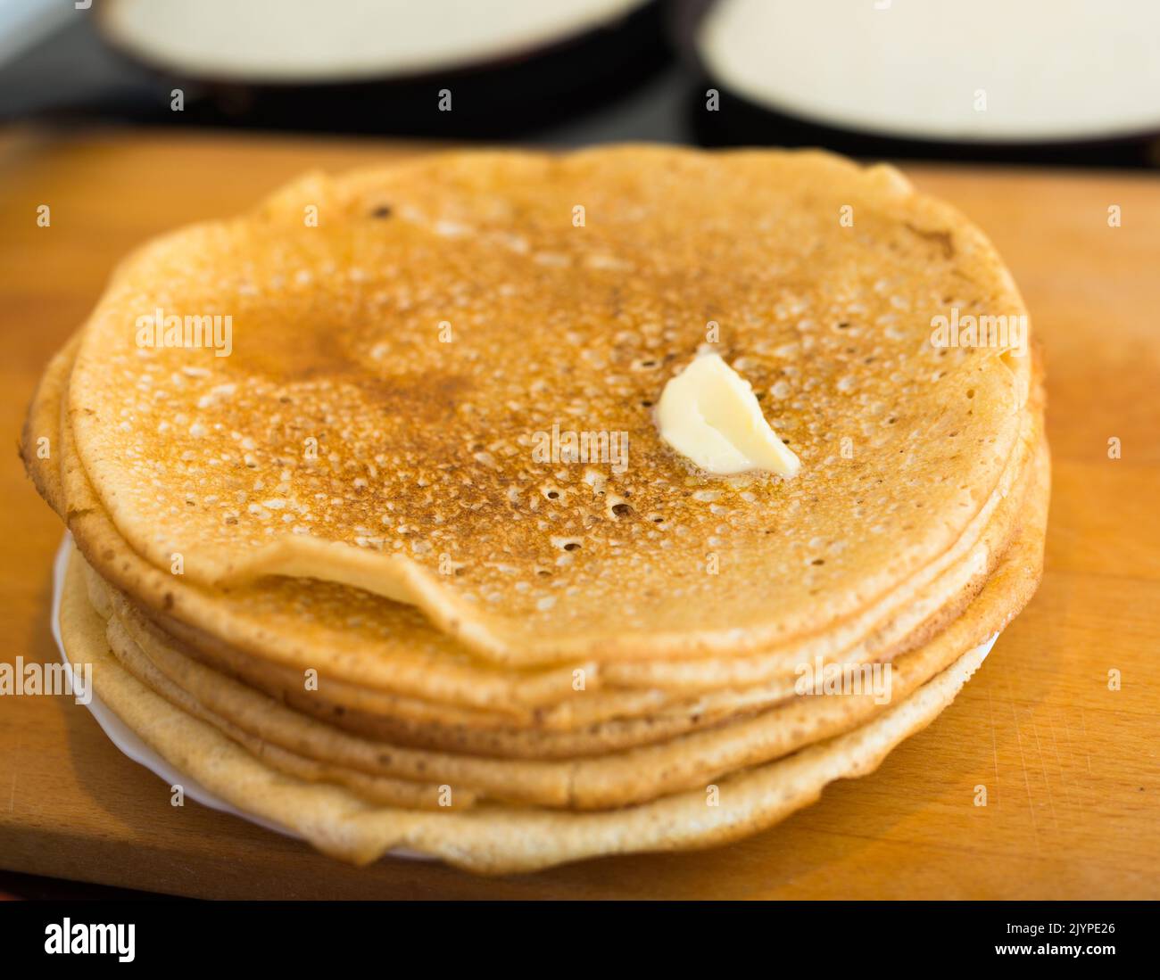 hot golden pancakes made from grain flour in kitchen while cooking on ...