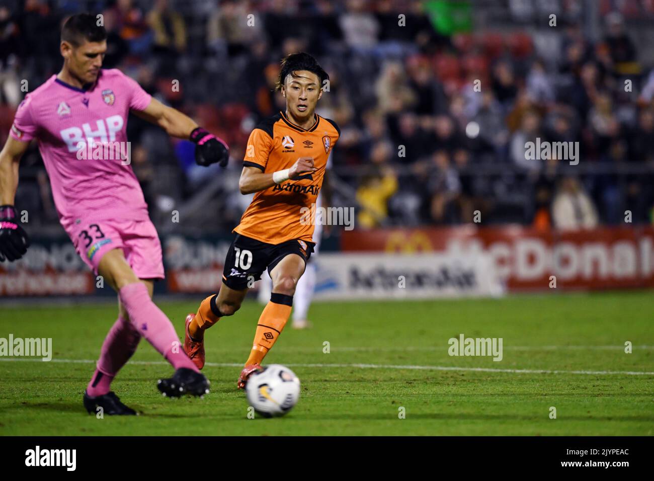 Riku Danzaki of the Roar (right) and goal keeper Liam Reddy of the ...