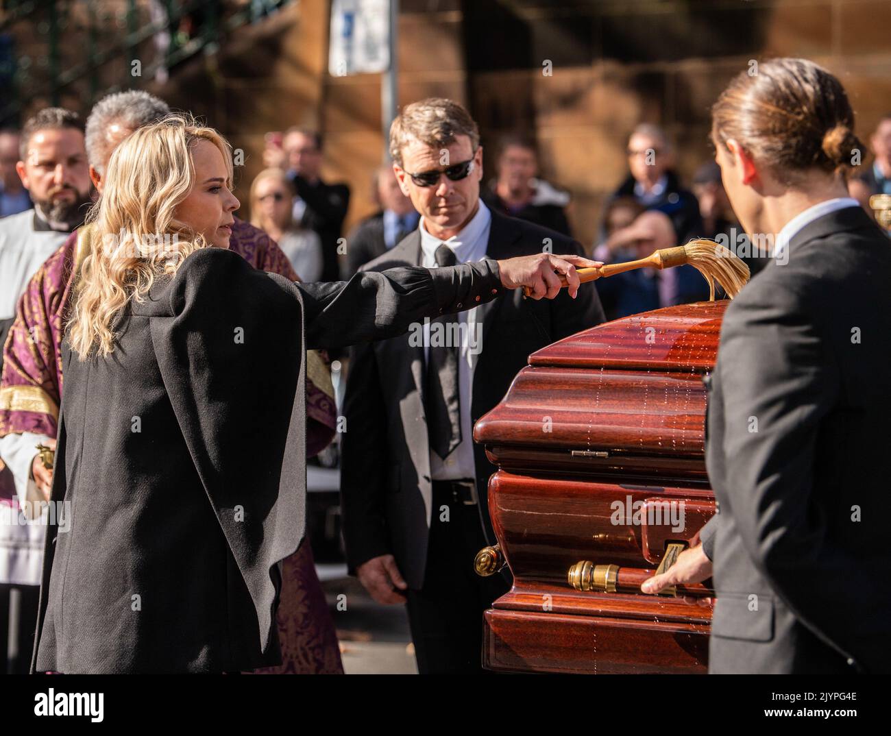 Family members brush the casket of Bob Fulton after the State Funeral ...
