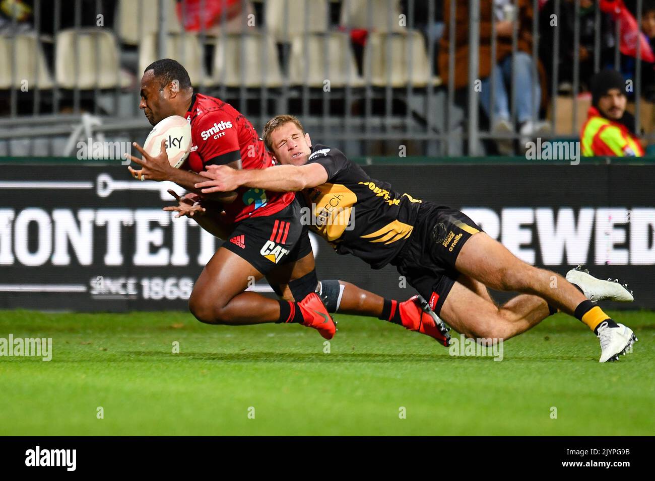 Manasa Mataele of the Crusaders scores a try in the tackle of Kyle ...