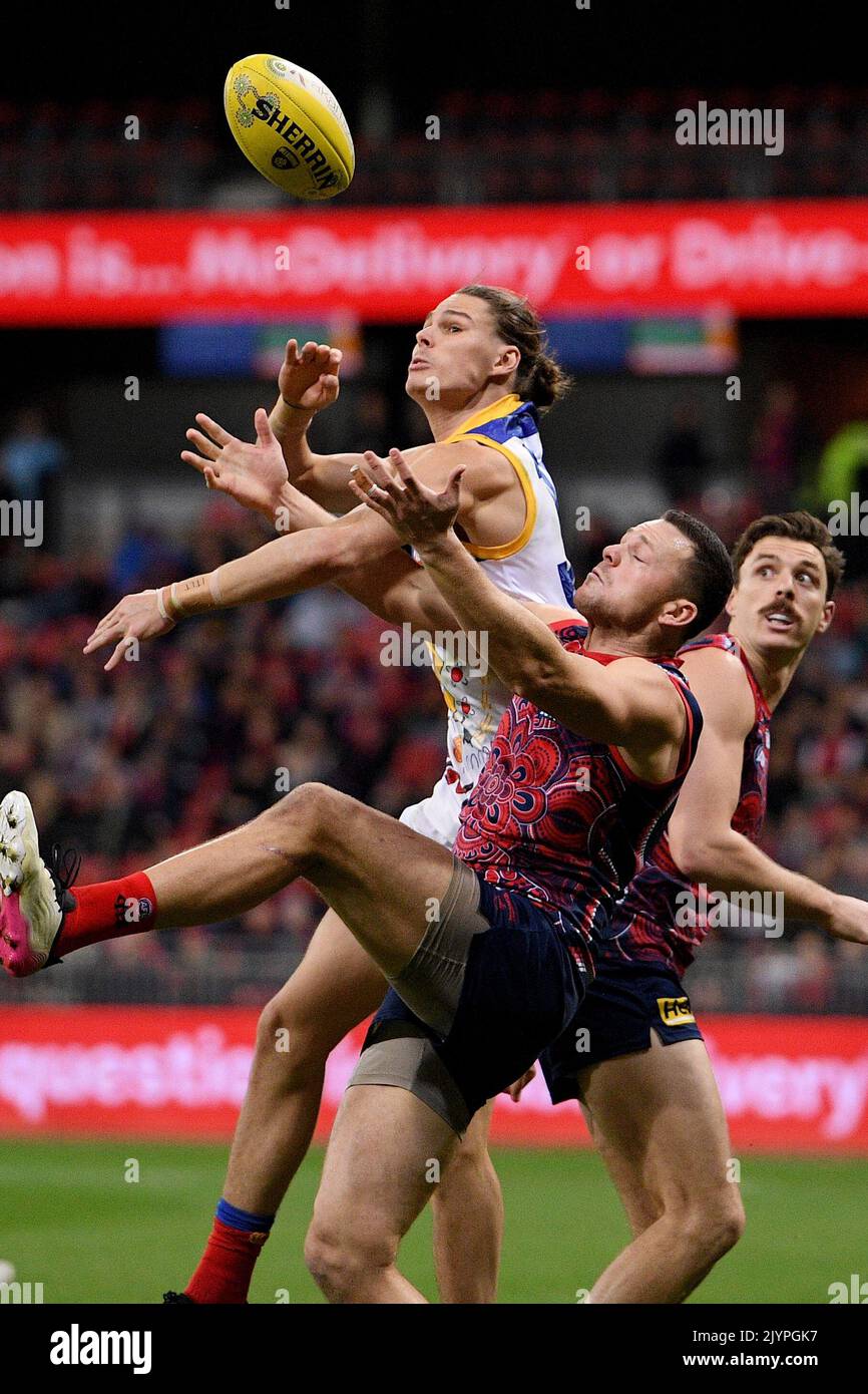 Eric Hipwood of the Lions contests for the ball with Steven May of the ...