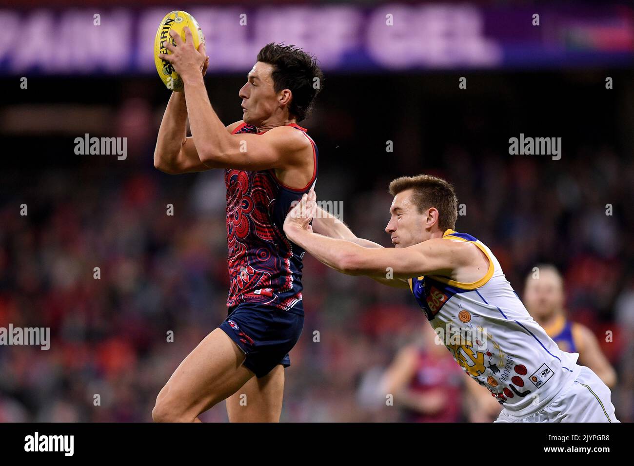 Sam Weideman of the Demons takes a mark over Harris Andrews of the ...
